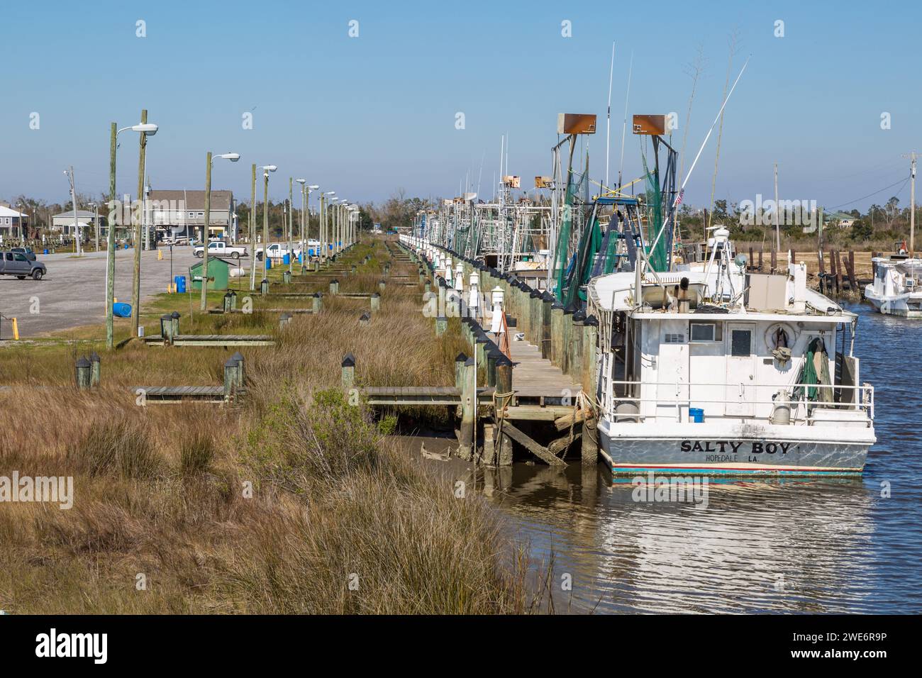 Commercial fishing boat Salty Boy docked at Bayou Caddy in a wetlands ...