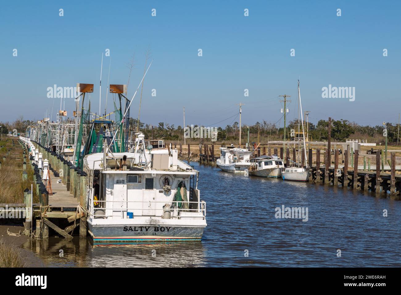 Commercial fishing boat Salty Boy docked at Bayou Caddy in a wetlands ...