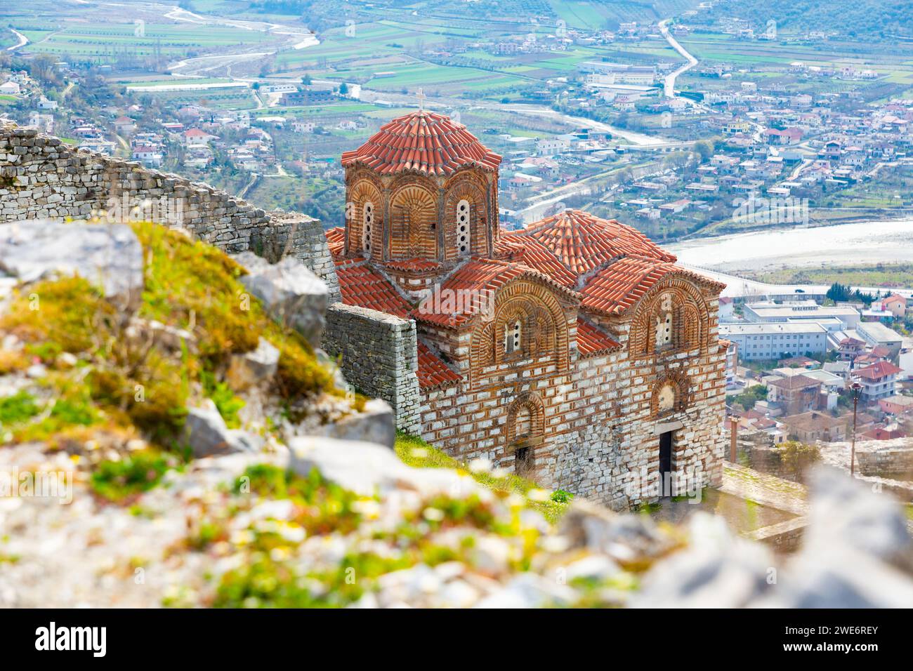 Medieval Holy Trinity Church on green flowering hill in Berat Stock ...