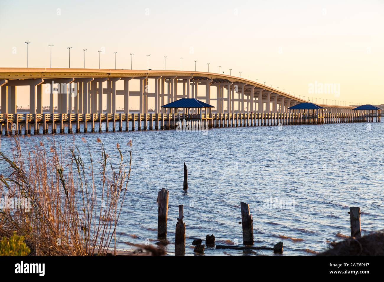 Fishing pier next to six lane highway 90 bridge over the Biloxi Back ...