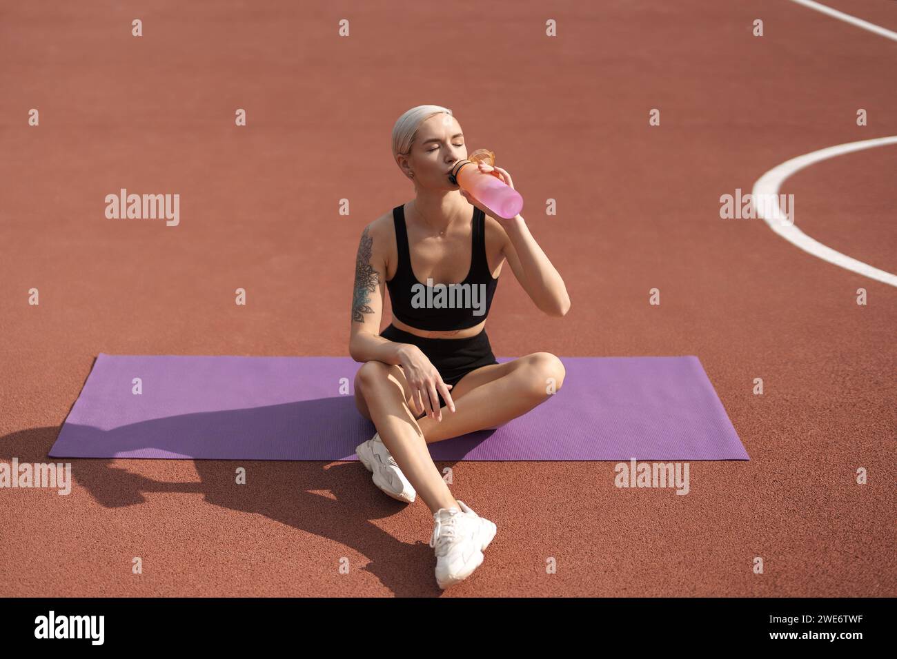 Hydration Break During Outdoor Fitness Routine Stock Photo - Alamy