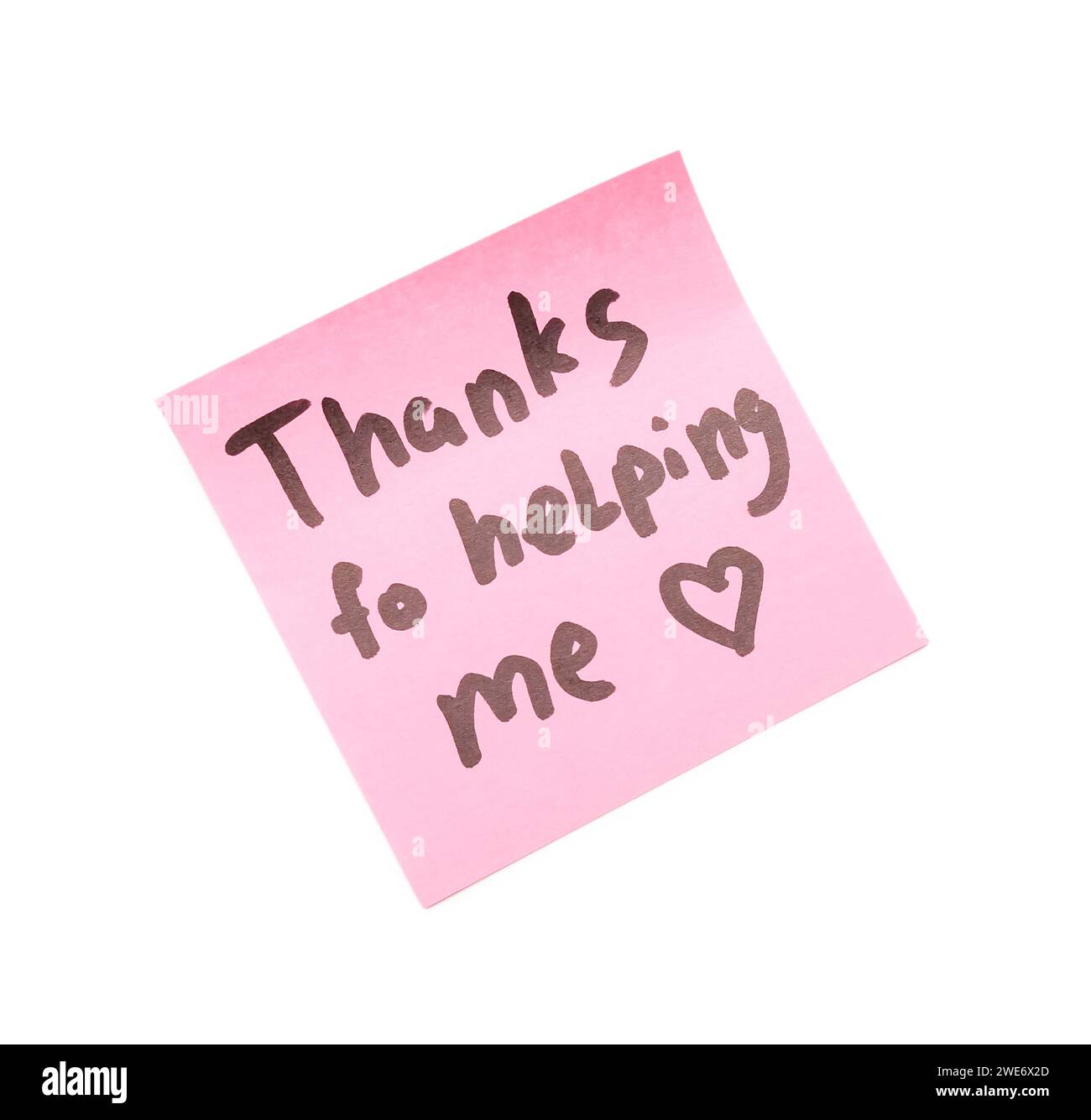 Sticky note with text THANKS FOR HELPING ME and drawn heart on white ...