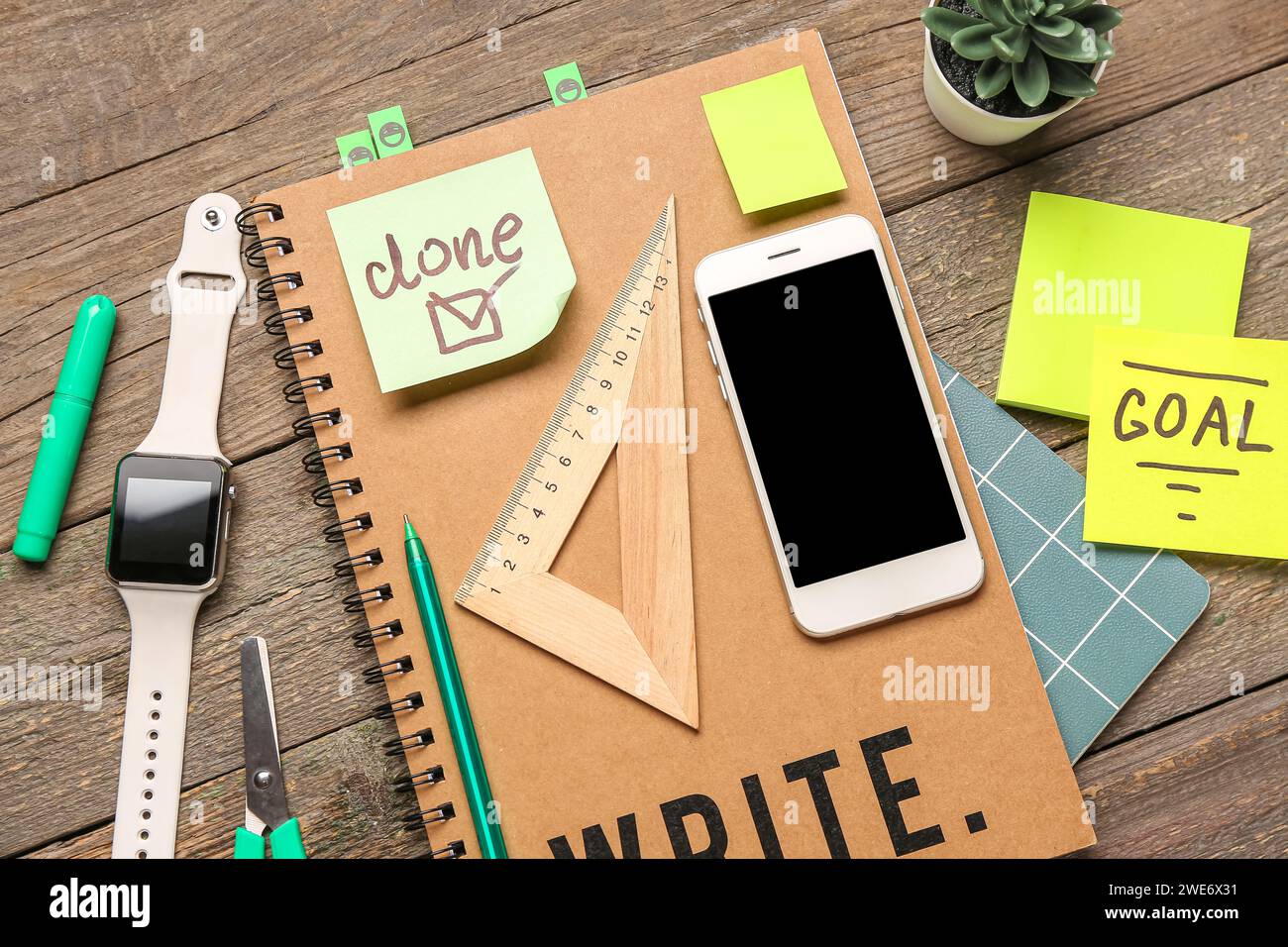 Sticky notes with stationery, mobile phone and smartwatch on wooden ...