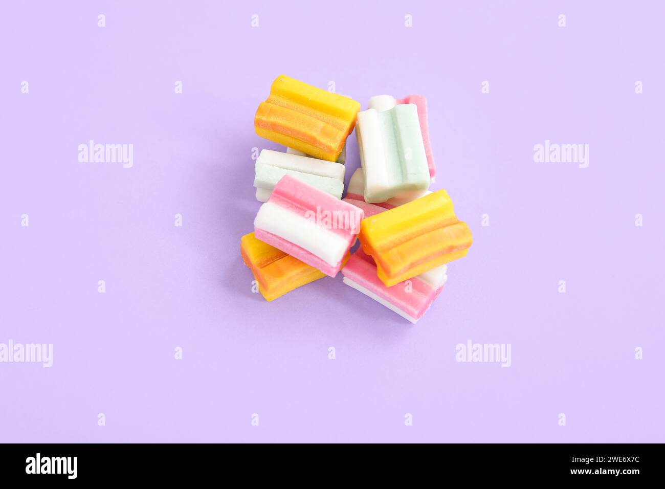 Color chewing gums on lilac background Stock Photo - Alamy