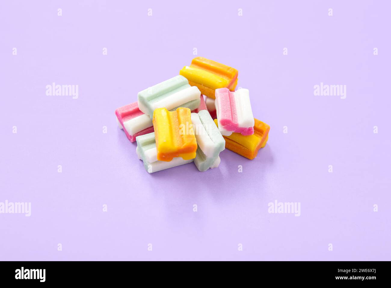 Color chewing gums on lilac background Stock Photo - Alamy
