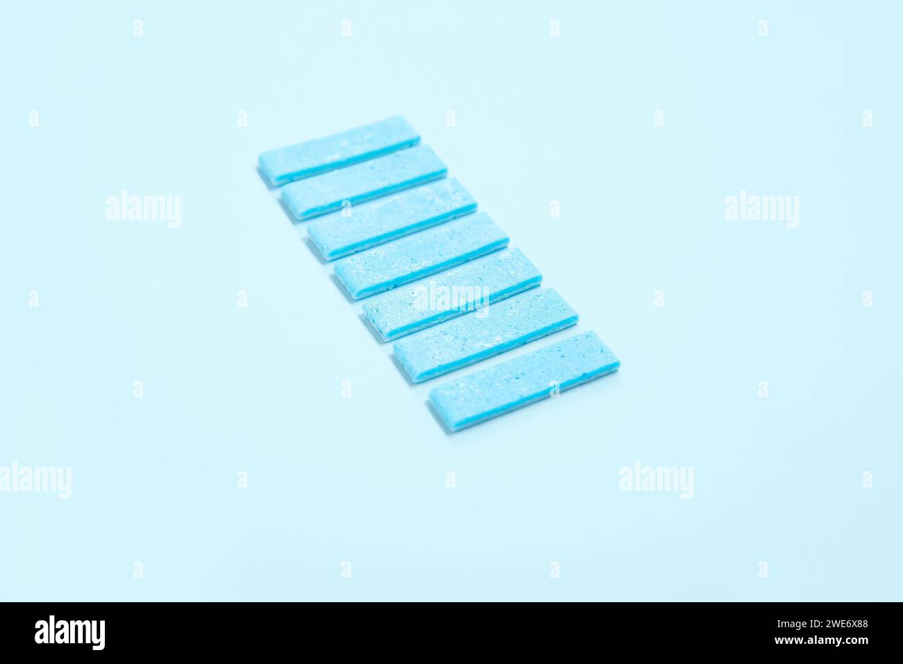 Color chewing gums on blue background Stock Photo - Alamy