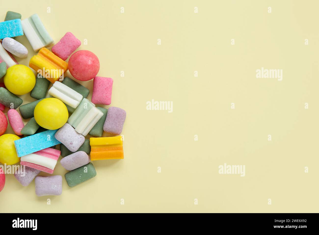 Different color chewing gums on yellow background Stock Photo - Alamy