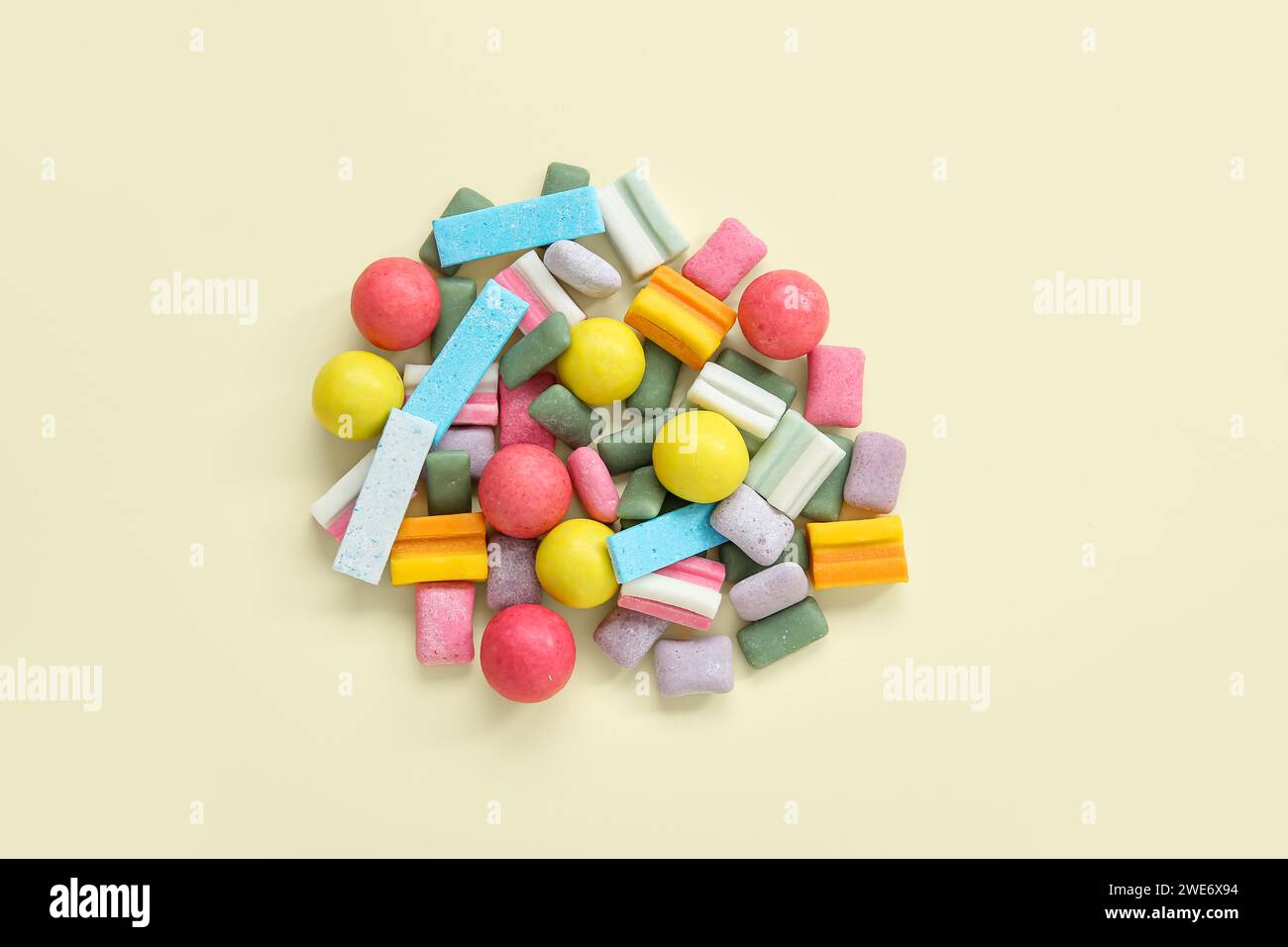 Different color chewing gums on yellow background Stock Photo - Alamy