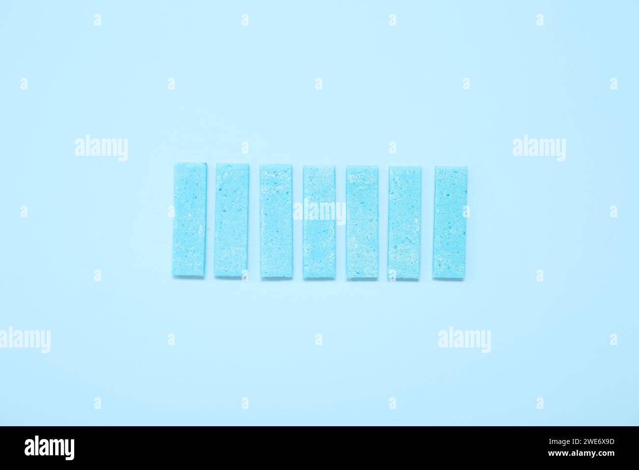 Color chewing gums on blue background Stock Photo - Alamy