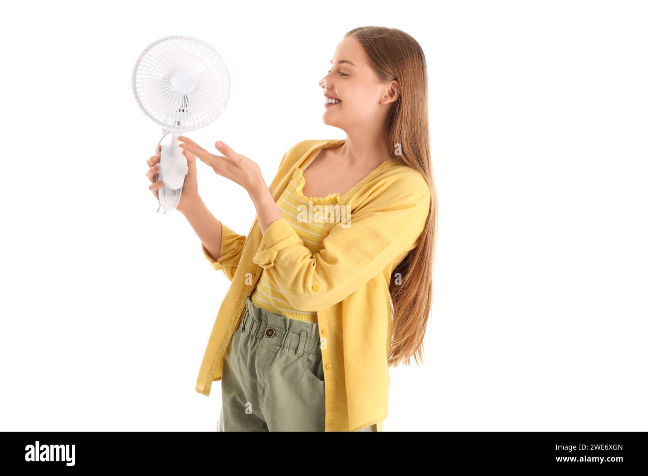 Young woman with electric fan on white background Stock Photo - Alamy