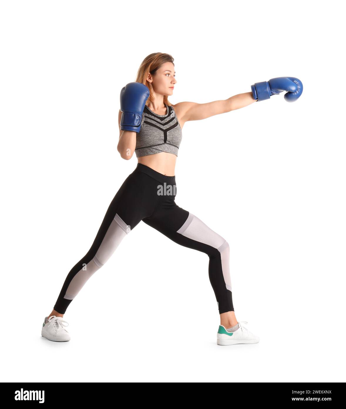 Young woman in boxing gloves training on white background. Concept of ...