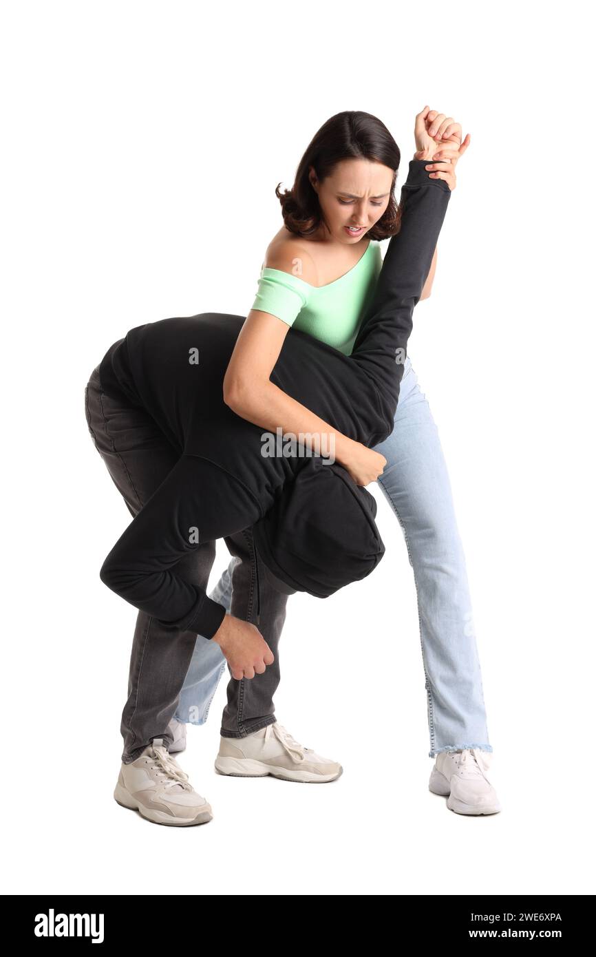 Young woman defending herself against robber on white background Stock ...