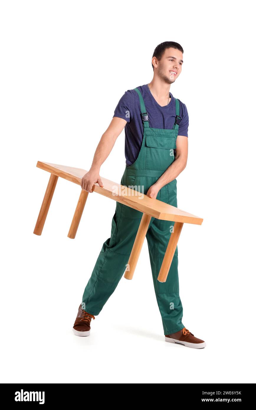 Young loader carrying wooden bench on white background Stock Photo - Alamy