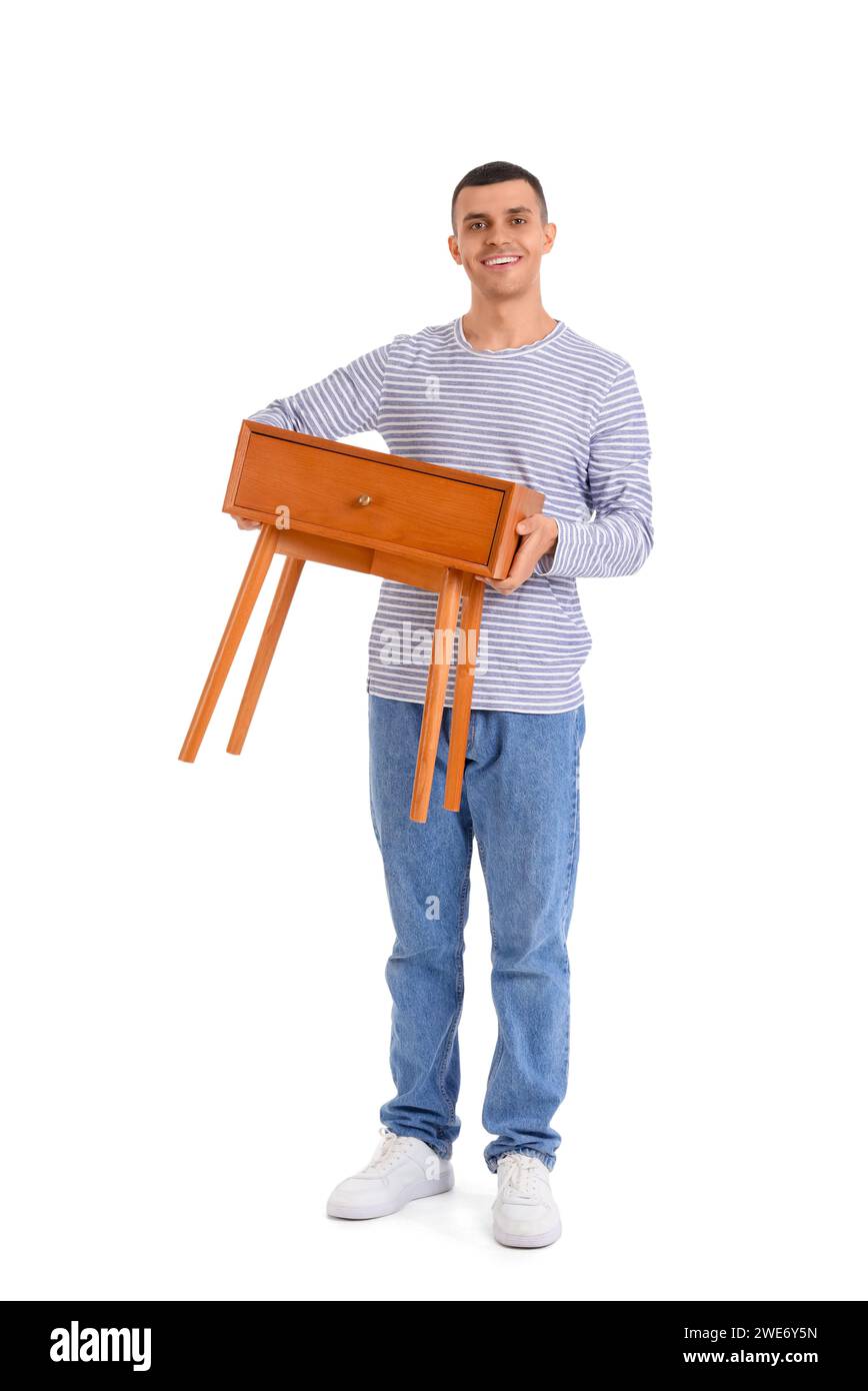Young man carrying table on white background Stock Photo - Alamy