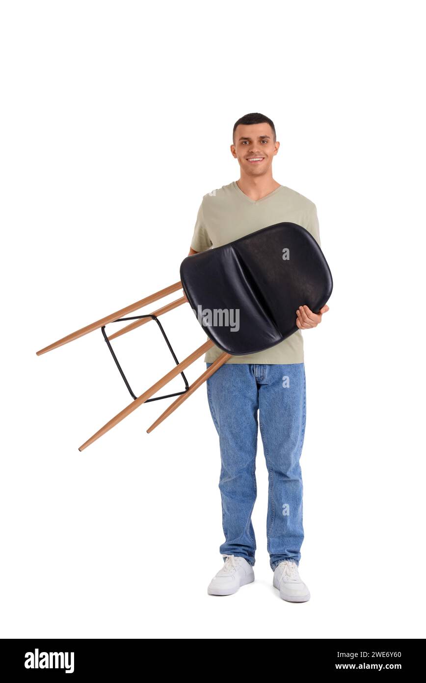 Young man carrying chair on white background Stock Photo - Alamy