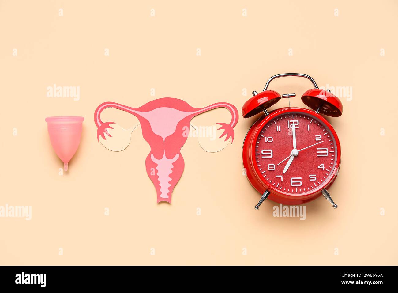 Menstrual cup, paper uterus and alarm clock on color background Stock ...