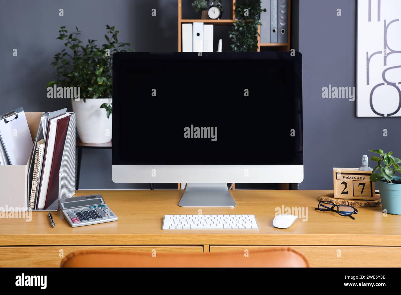 Blank computer monitor with documents on table in office Stock Photo ...