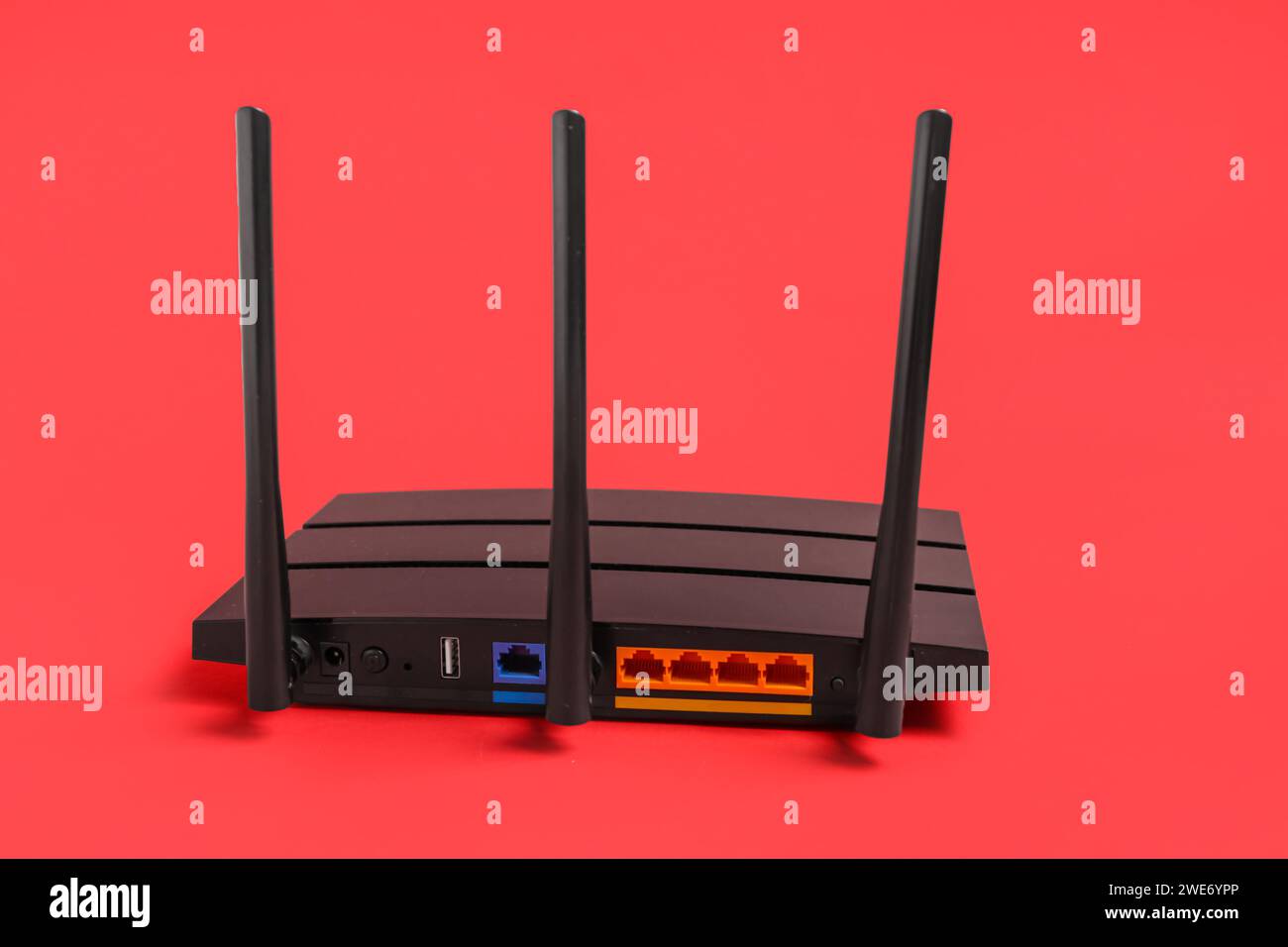 Modern wi-fi router on red background Stock Photo - Alamy