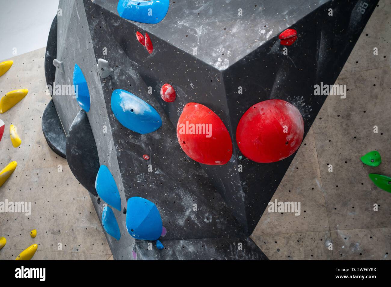 Closeup of climb wall with red and blue grips in contemporary gym ...