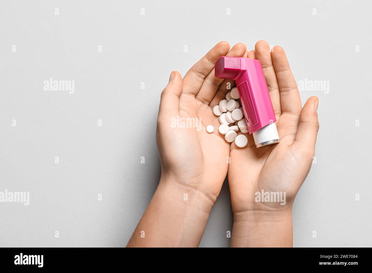 Child's hands with asthma inhaler and pills on white background Stock ...