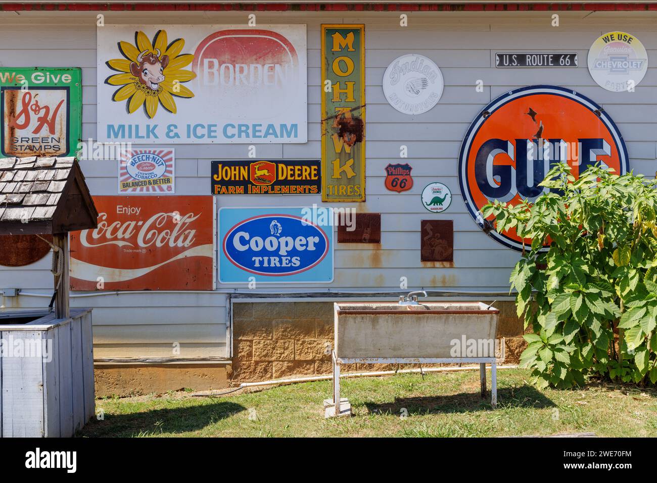 Antique metal advertising signs used for decoration on the side of a ...