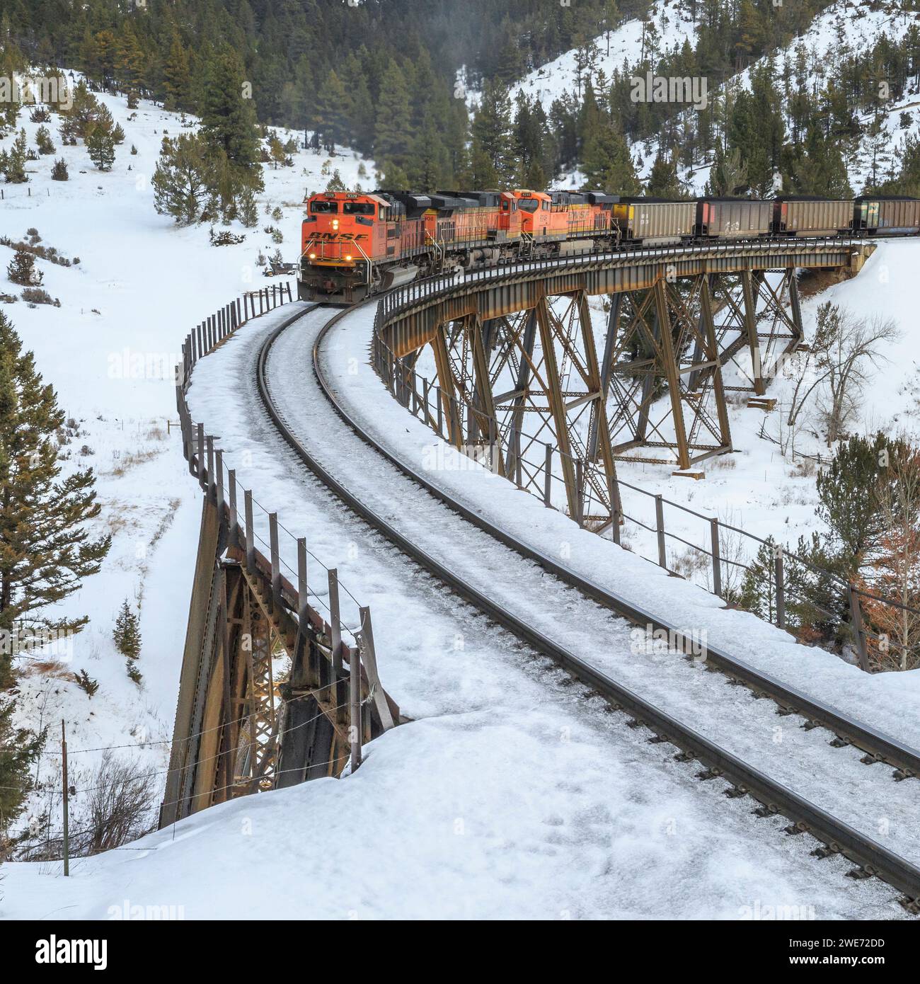 train hauling coal cars toward mullan pass over a trestle in winter near austin, montana Stock ...
