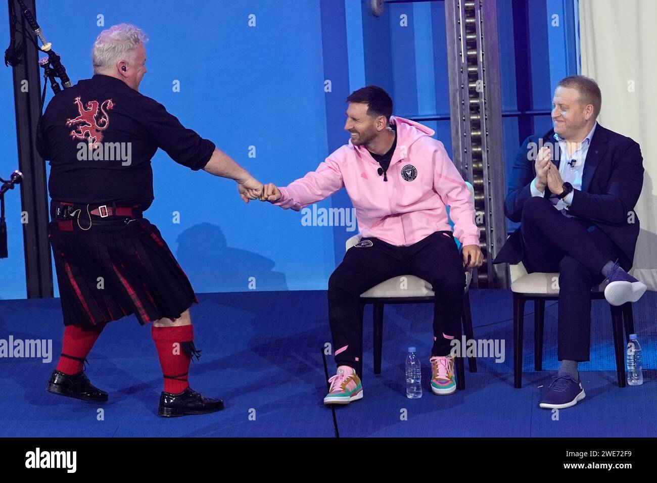 Inter Miami soccer player Lionel Messi, center, bumps fists with a ...