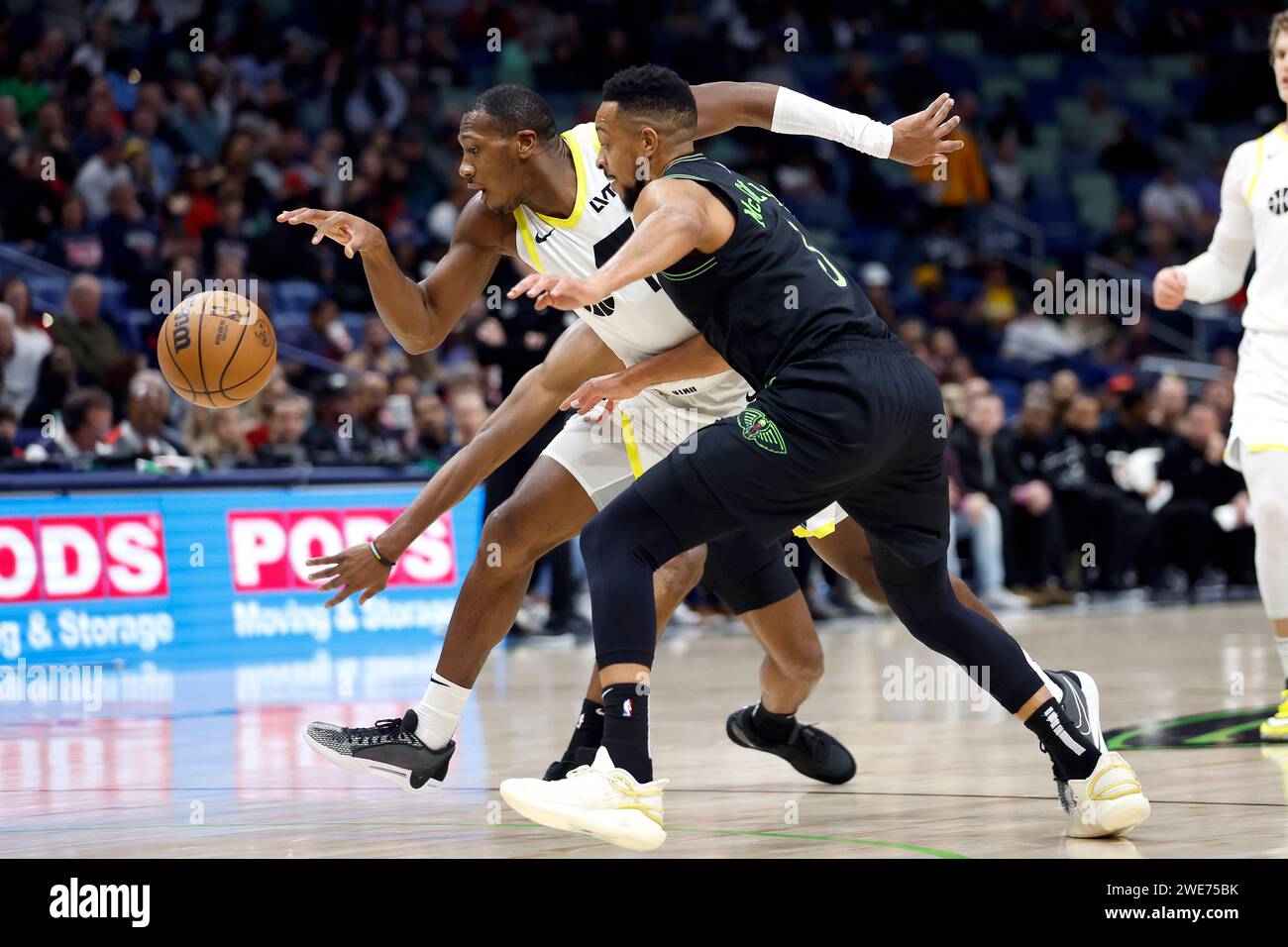 Utah Jazz guard Kris Dunn reaches for the ball next to New Orleans ...