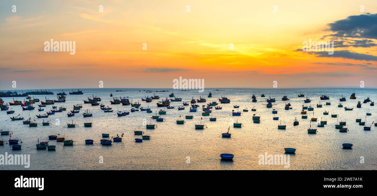 Mui Ne fishing village in sunset sky with hundreds of boats anchored to ...