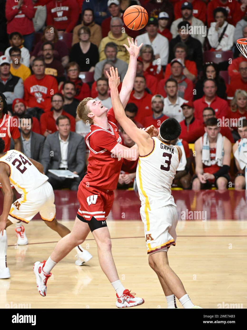 Wisconsin forward Steven Crowl, left, collides with Minnesota forward ...