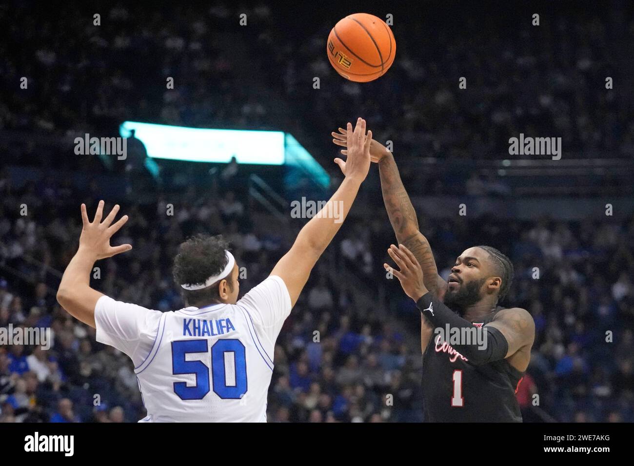 Houston guard Jamal Shead (1) shoots as BYU center Aly Khalifa (50 ...