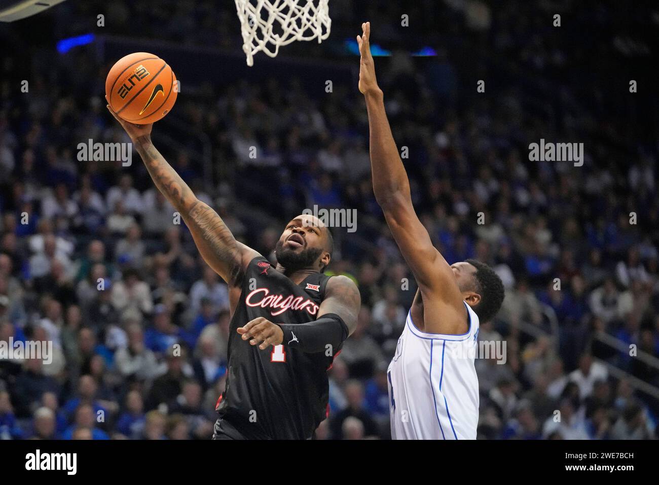 Houston guard Jamal Shead (1) goes to the basket as BYU forward Atiki ...