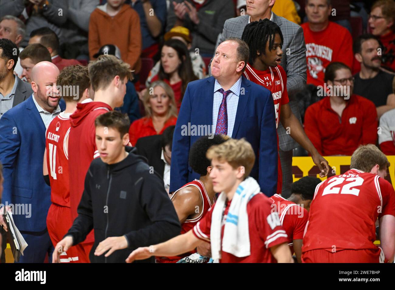 Wisconsin head coach Greg Guard checks the scoreboard during a break in ...