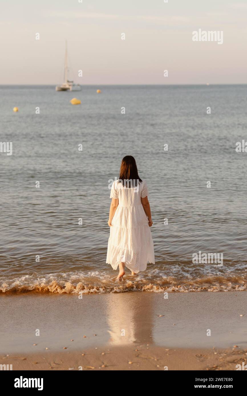 Luxury portrait of woman in white dress at the beach, Albufeira ...