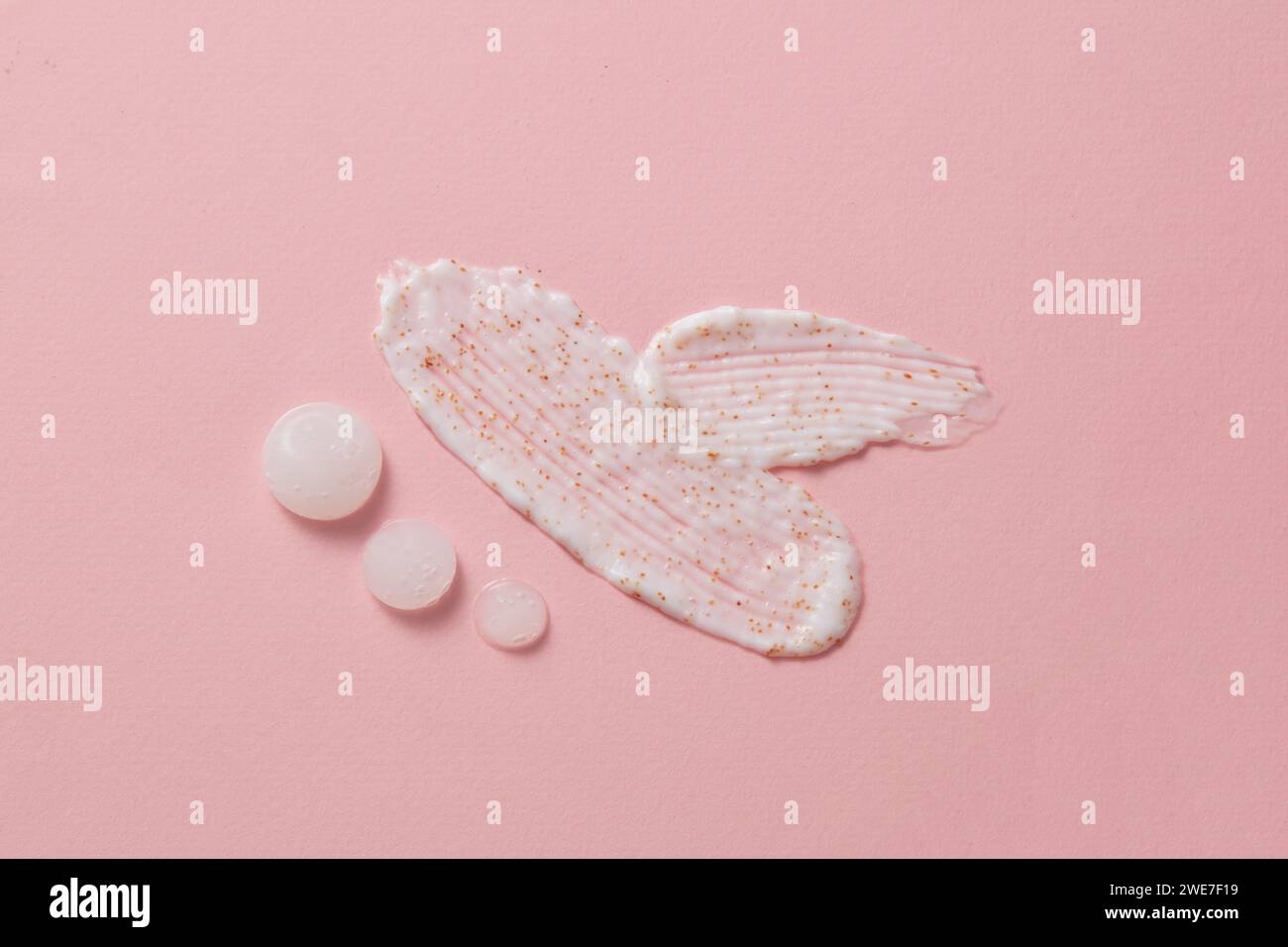 White exfoliation cream smear smudge sample decorated on pink ...