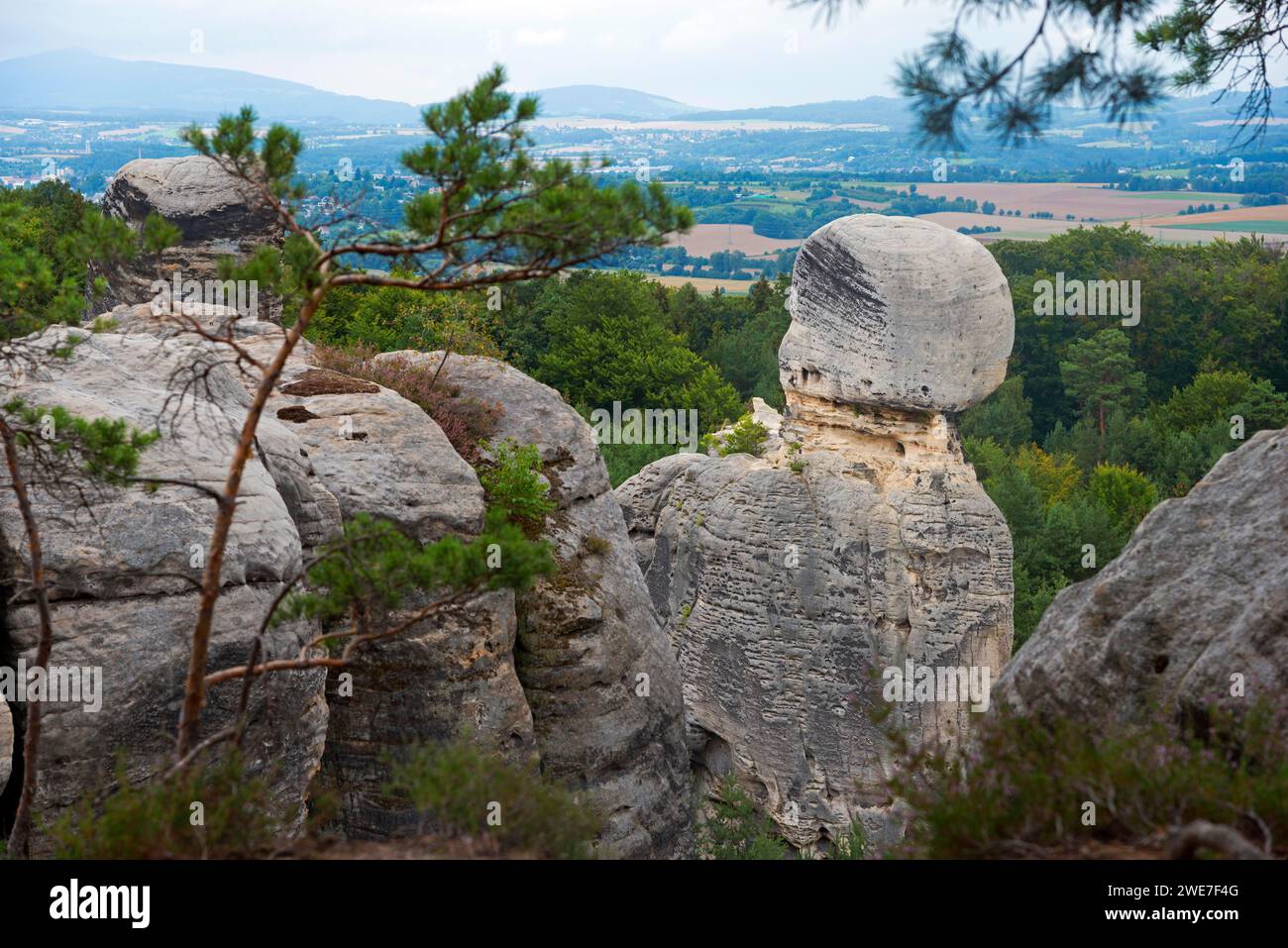 Nature view with imposing rocks and trees in front of a cloudy sky ...