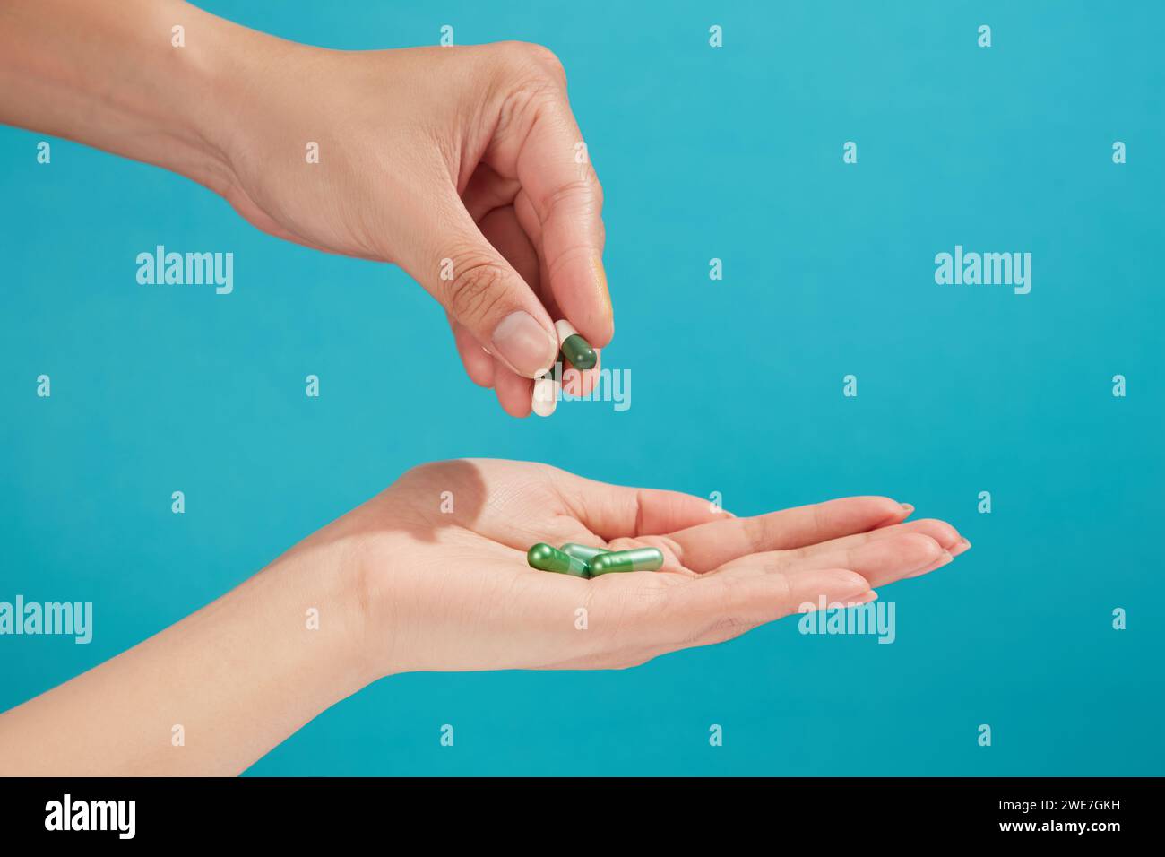 Doctor putting medicine capsules hand hi-res stock photography and ...