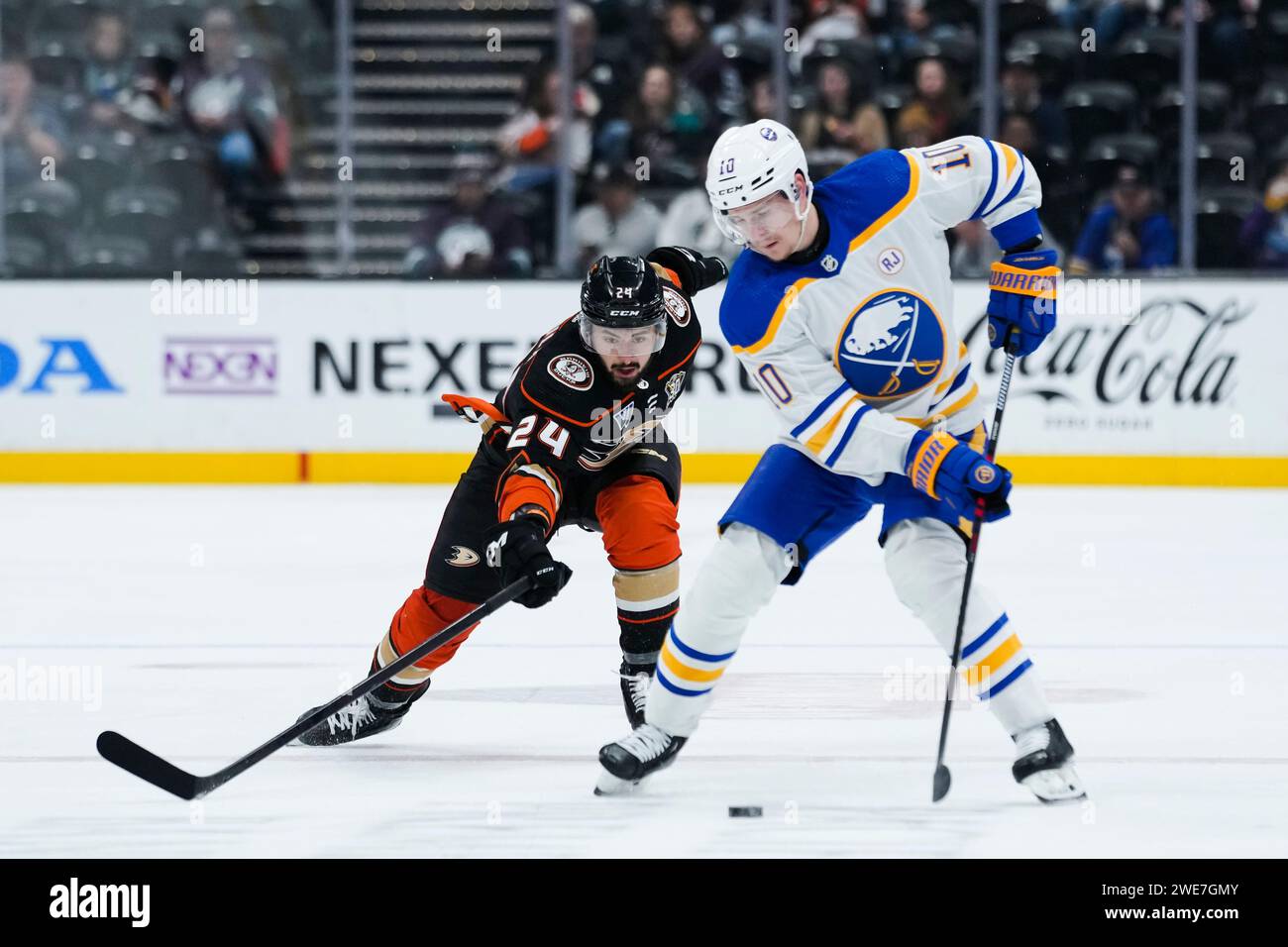 Anaheim Ducks center Bo Groulx, left, lunges for the puck past Buffalo ...