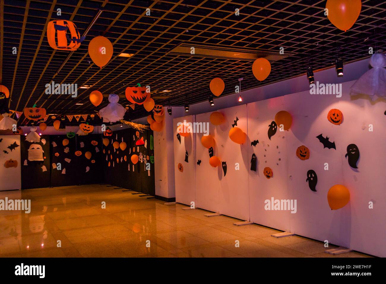 Dimly lit room decorated with hand made Halloween decorations of ghost ...