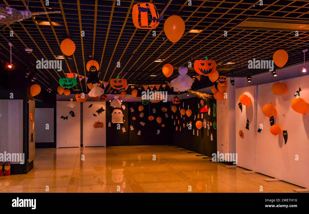 Dimly lit room decorated with hand made Halloween decorations of ghost ...