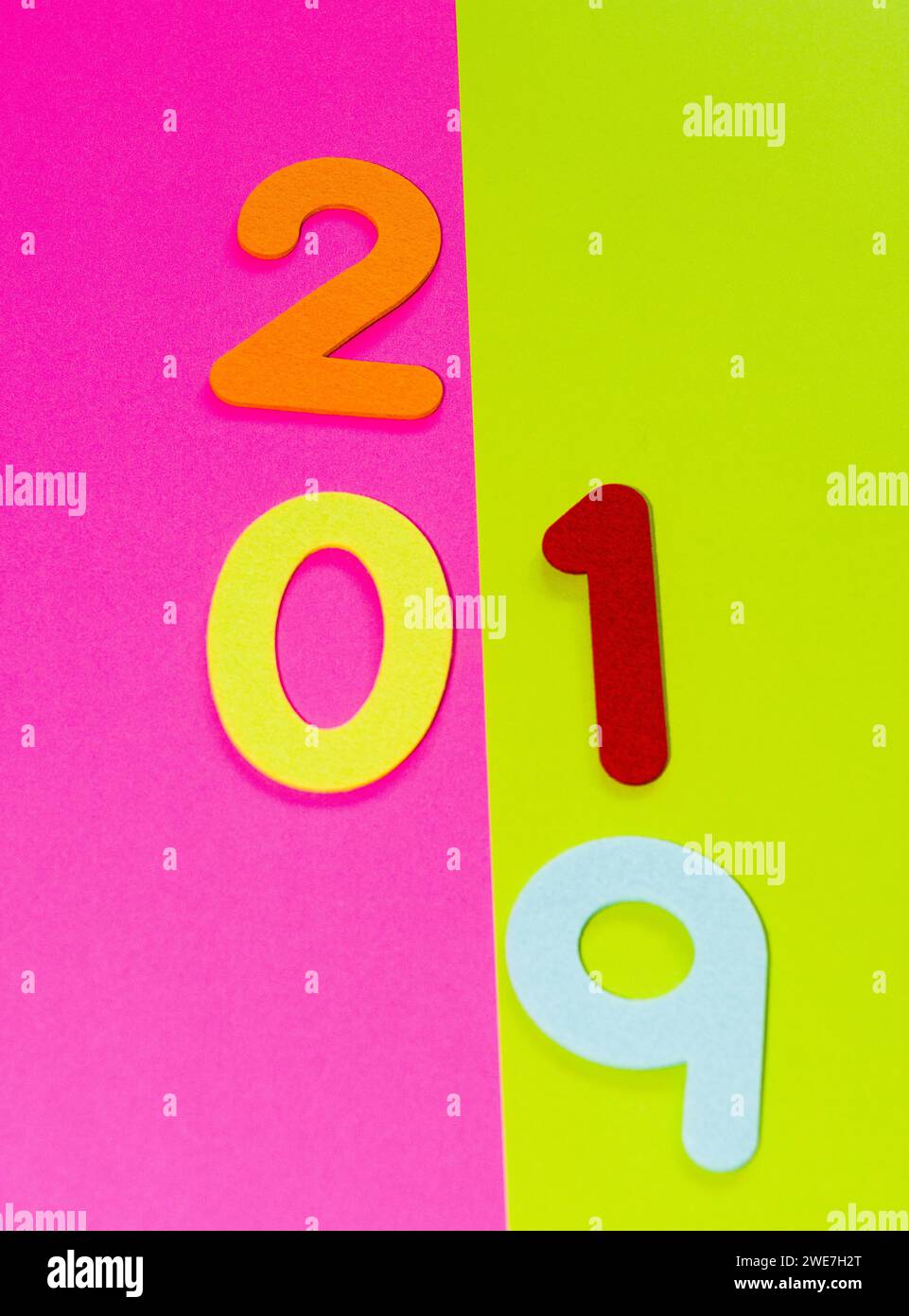 The numbers 2019 made of felt of different colors photographed on pink ...