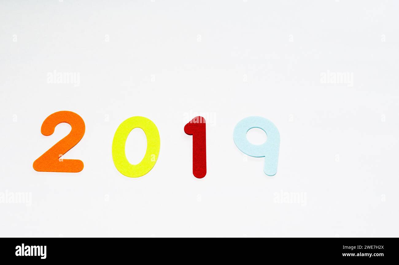 The numbers 2019 made of felt of different colors photographed on white ...