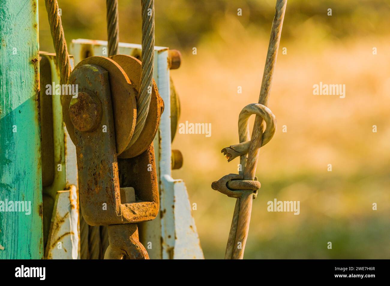 Closeup of a rusty pulley assembly with a blurred background in South ...