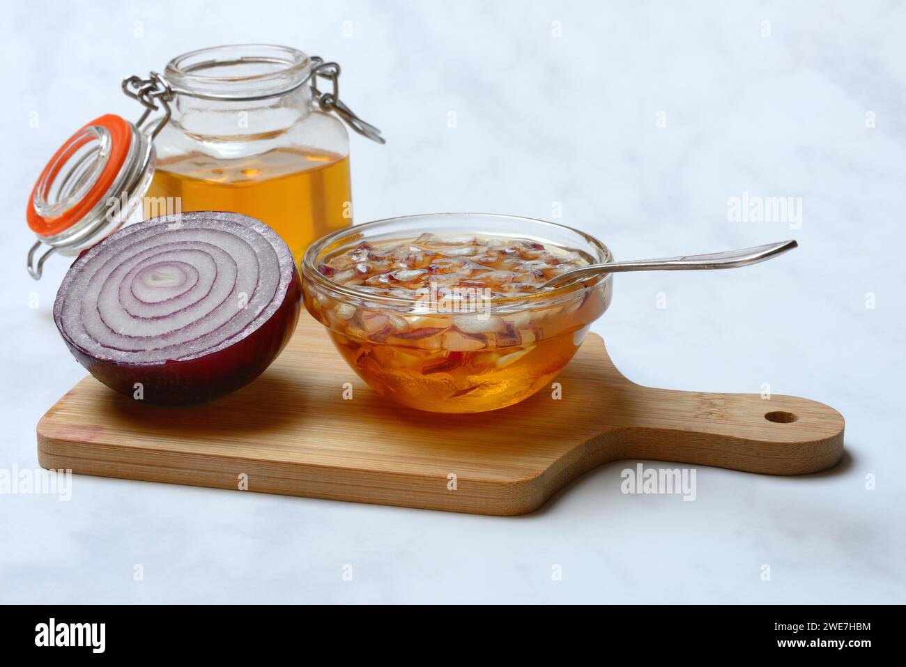 Honey in a jar and chopped onion as ingredients for cough syrup Stock ...