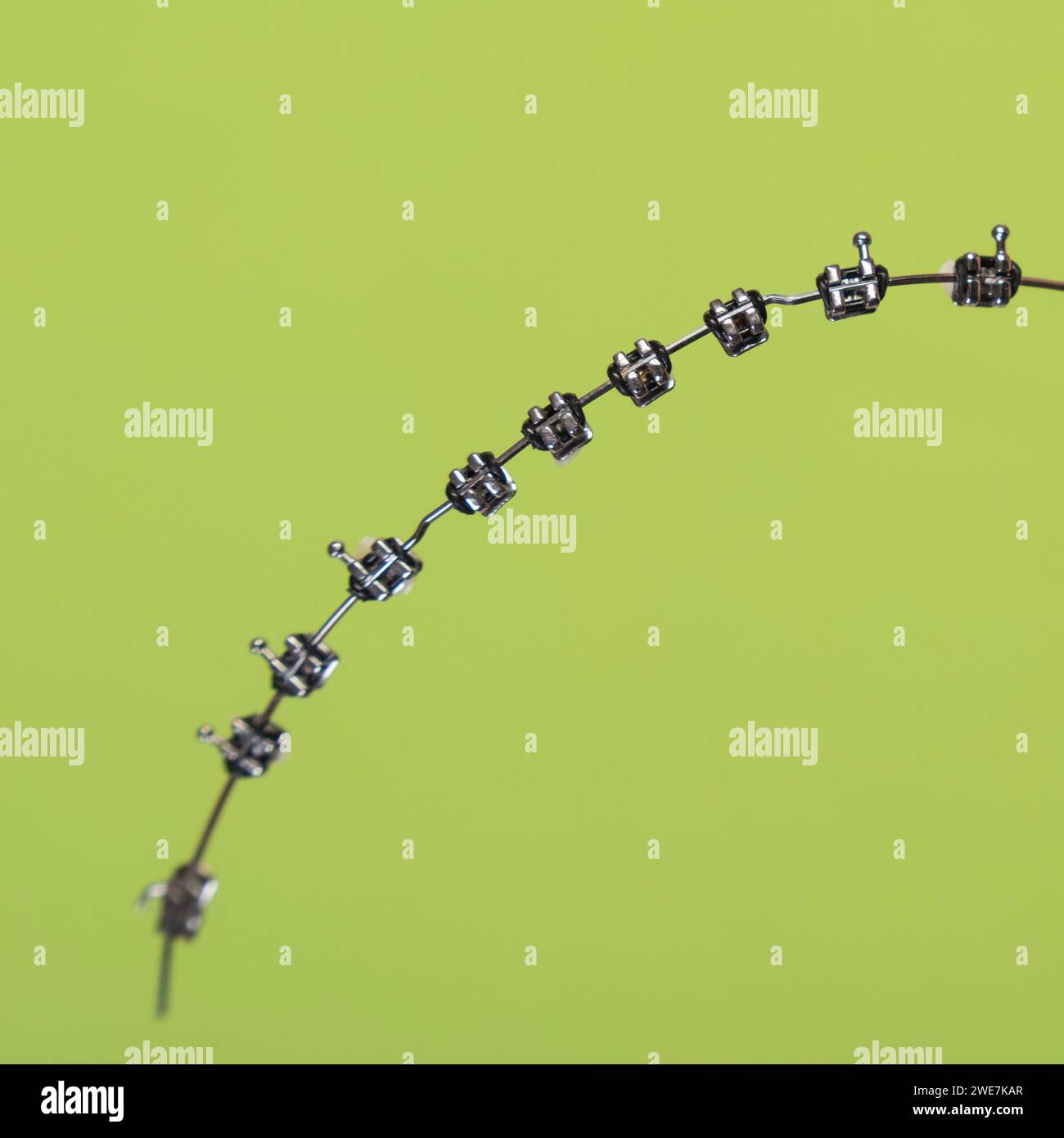 Wire with brackets of braces in front of a monochrome background Stock ...