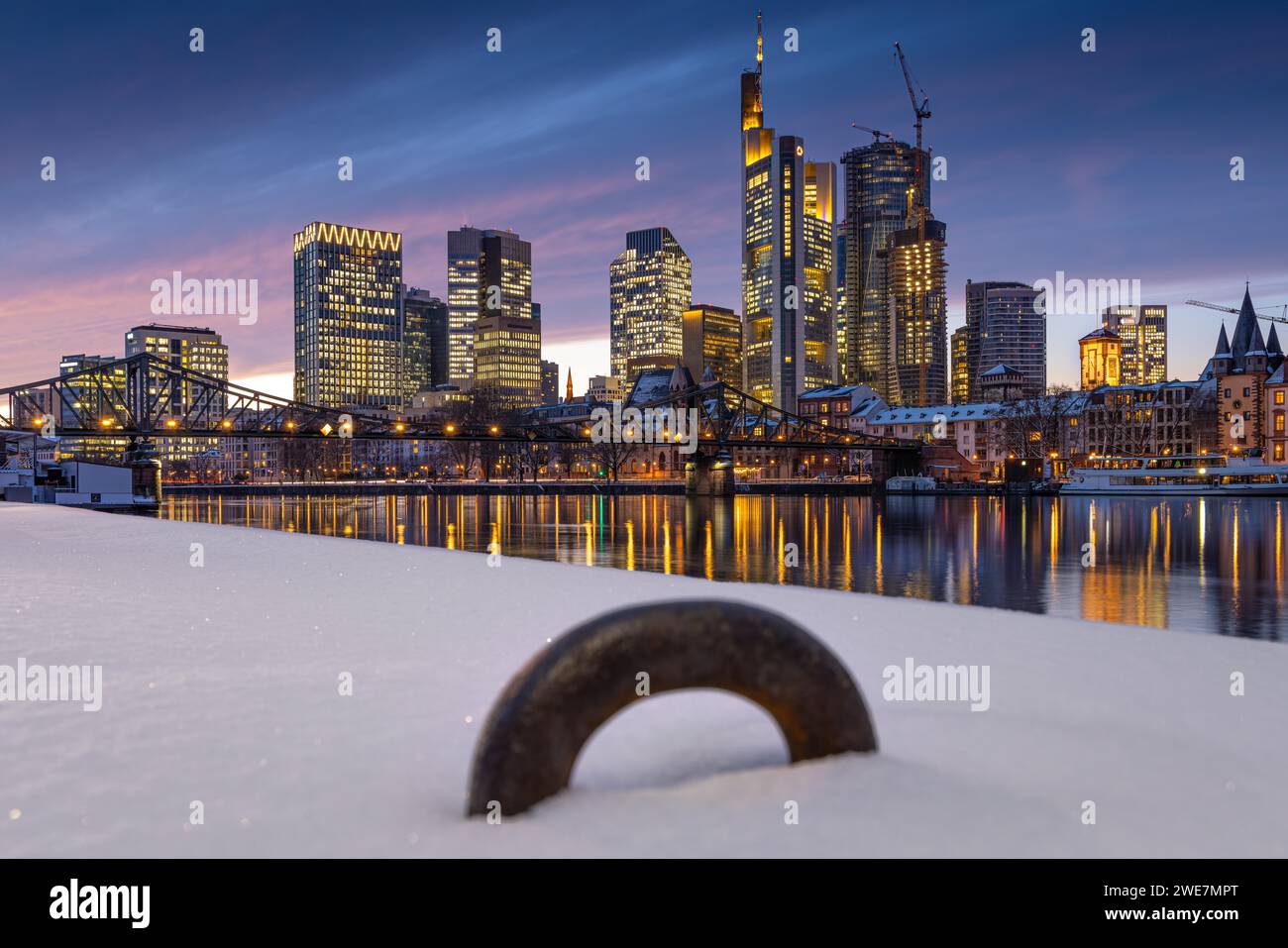 The lights of the snow-covered Frankfurt banking skyline glow in the evening, Frankfurt am Main ...