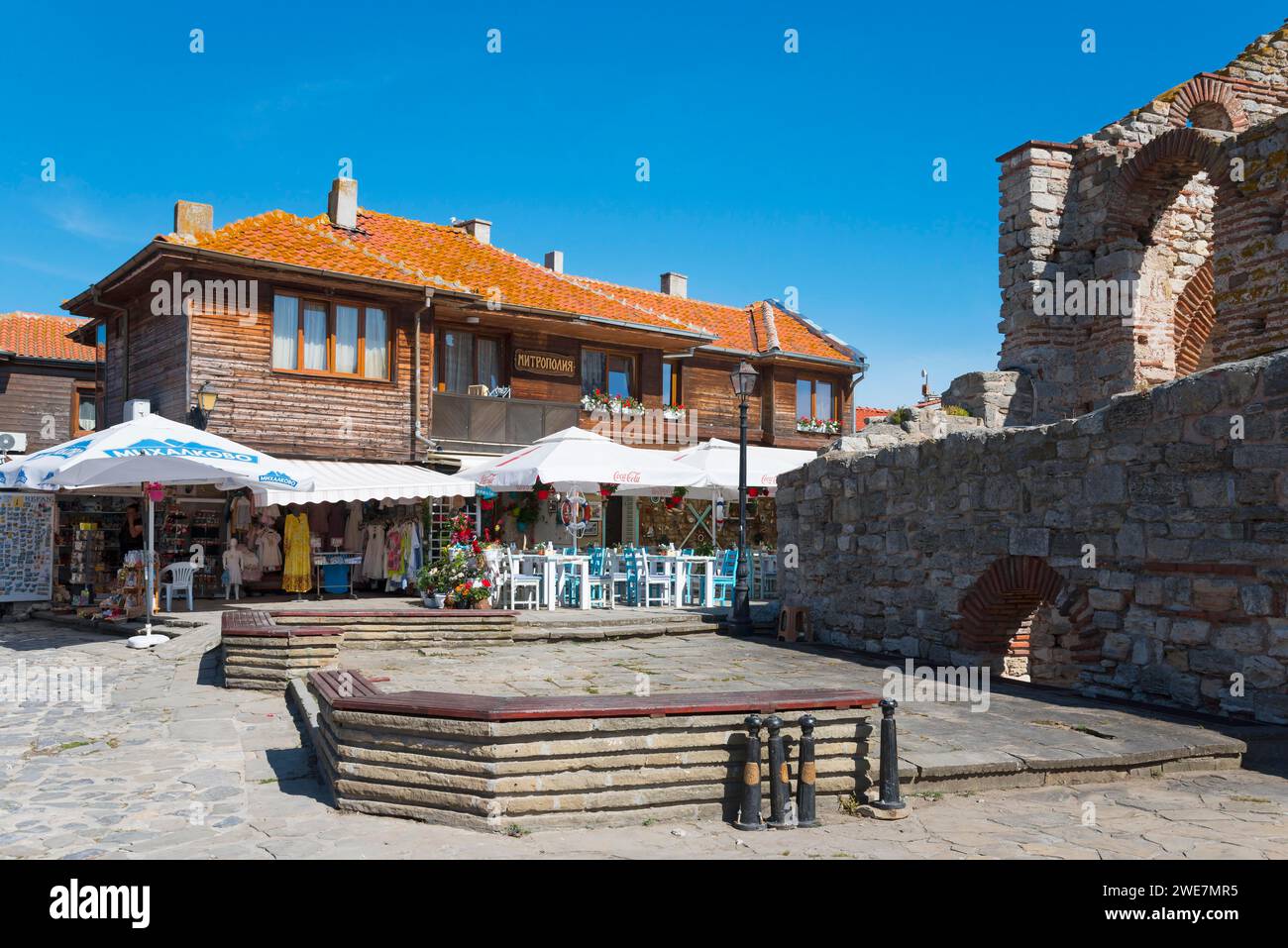 Traditional two-storey wooden house with restaurant and adjoining shops ...