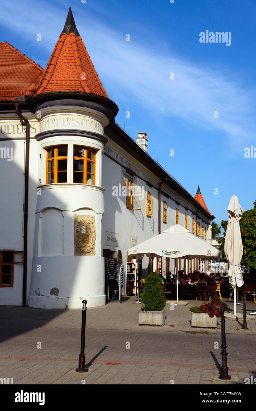 Historic building with a pointed roof and an outdoor terrace on a ...