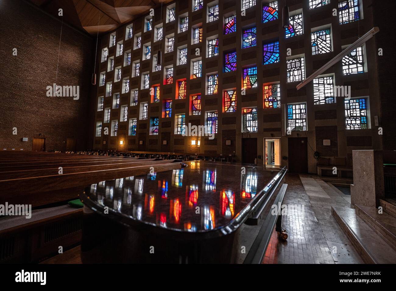 Interior view of a church with colourful stained glass windows and ...