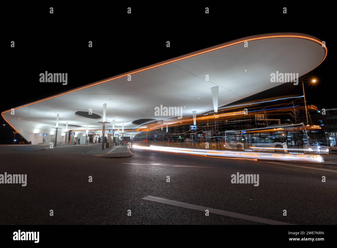 Long exposure of a modern bus station in the evening with light traces ...